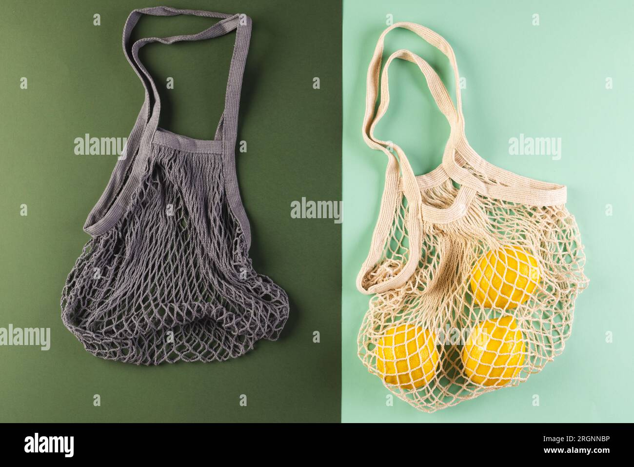 Brown and white mesh net bags with lemons and copy space on light and ...