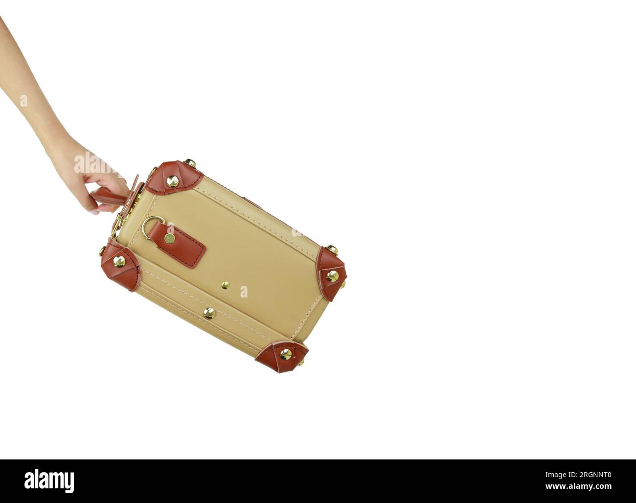 Travel concept. Female hand holding an old fashioned suitcase isolated ...