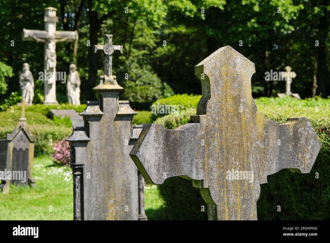 Catholic cemetery with old tombstones and crucifixion statue on a sunny day in spring. Image ...
