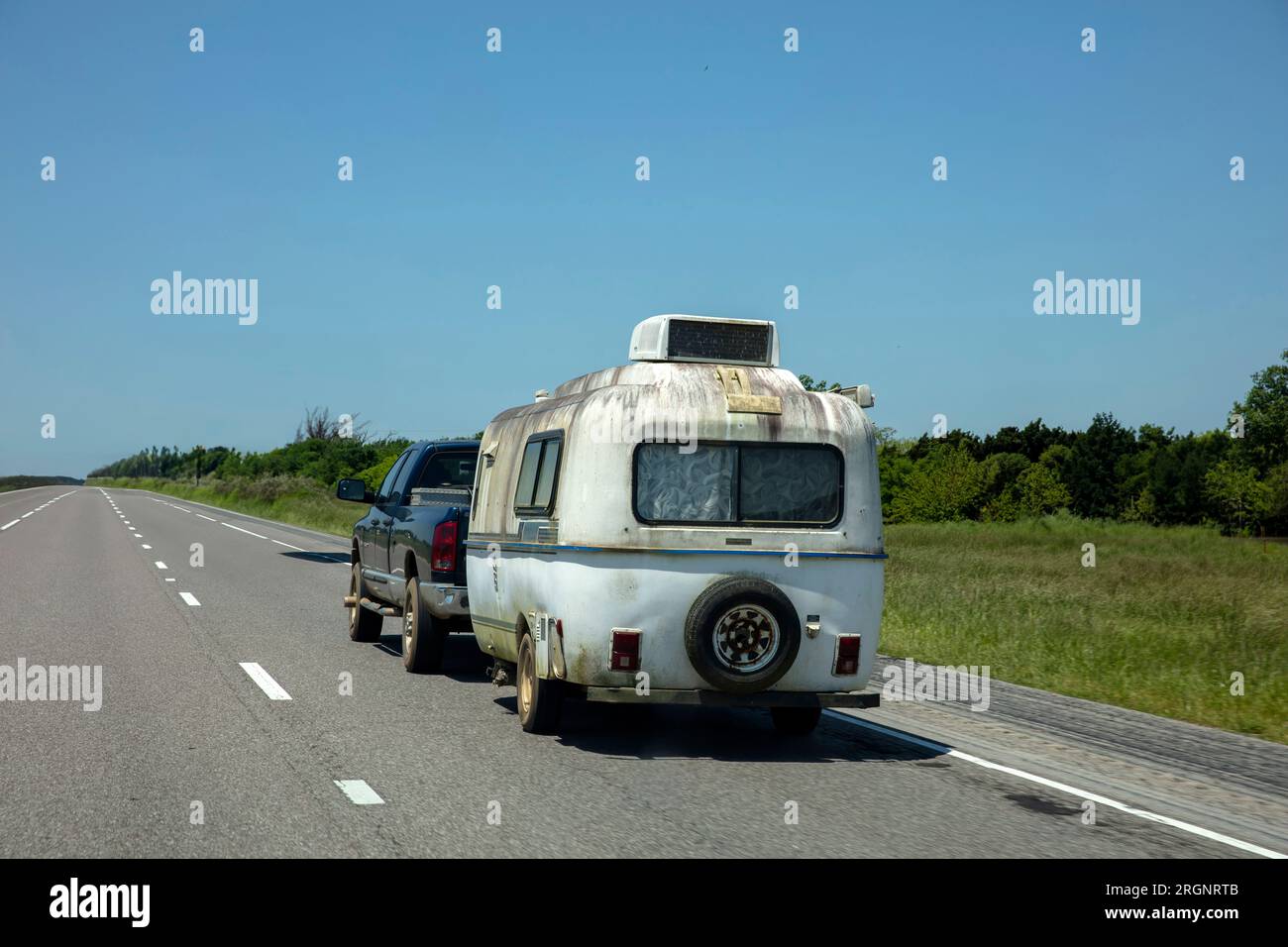 Rear view of truck with RV camper parked at highway roadside in USA ...