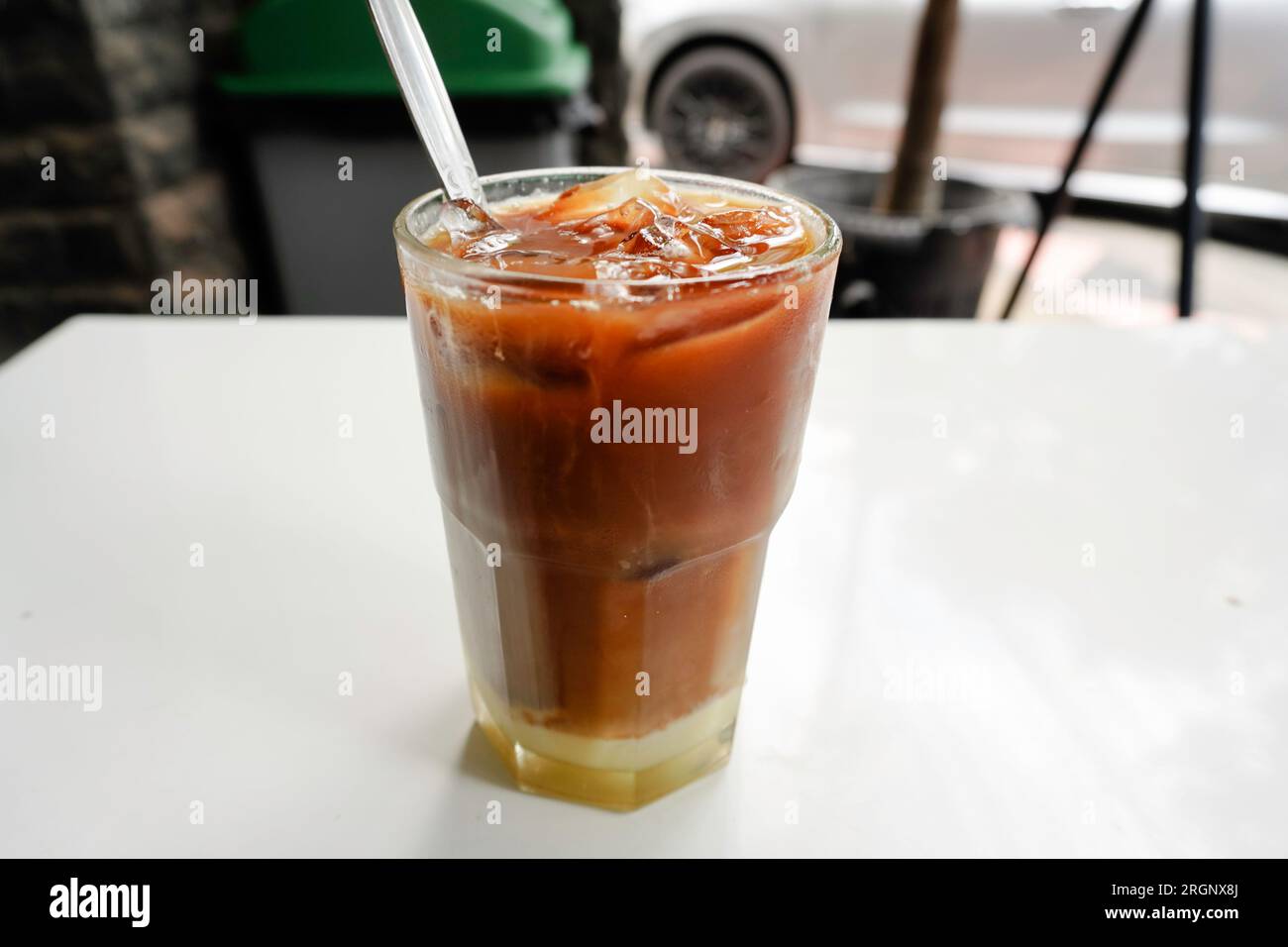 A glass of iced coffee milk kopitiam style, showing separate in a layer ...