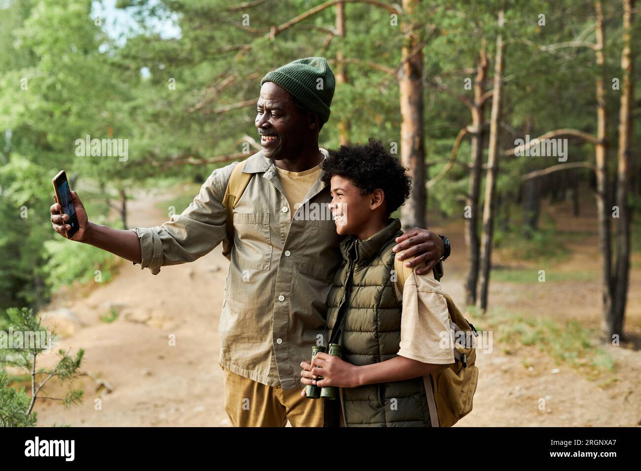 African American dad and his son having video call on smartphone during ...