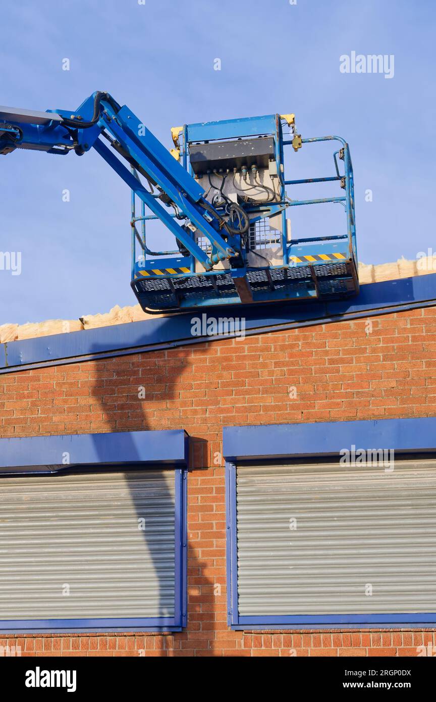 Access platform equipment powered high in sky at construction building ...