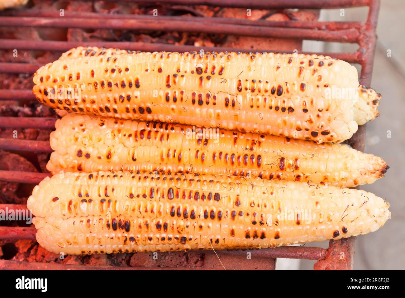 barbecue corn on the back of the stove Stock Photo - Alamy