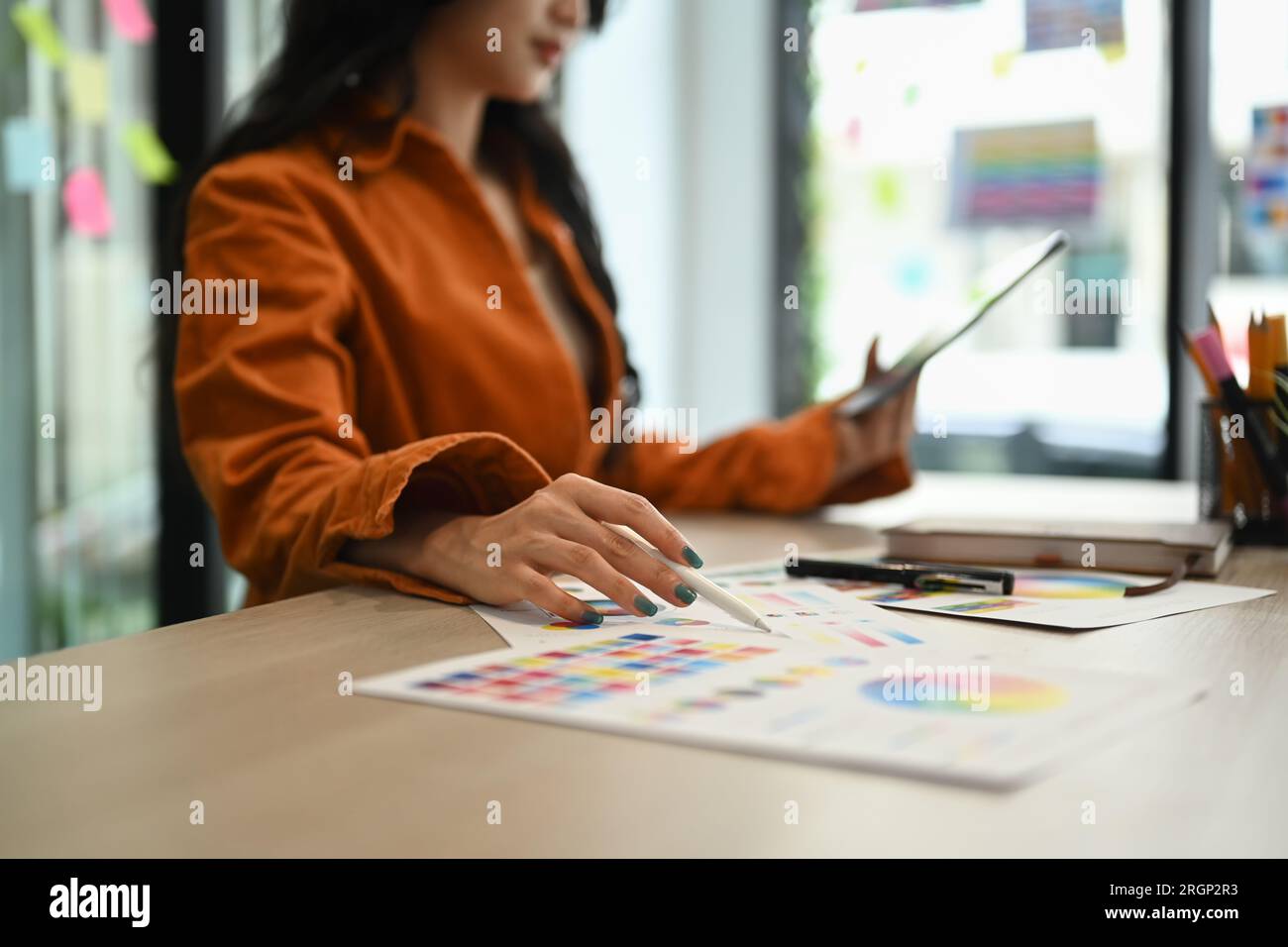Young designer choosing colors from color swatch samples chart at ...