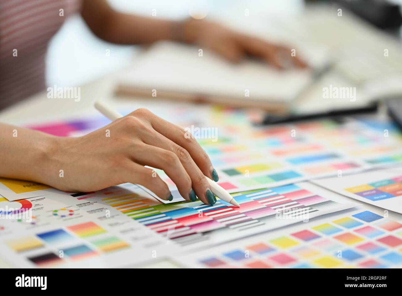 Closeup sot of designer working with color swatch samples chart for new ...