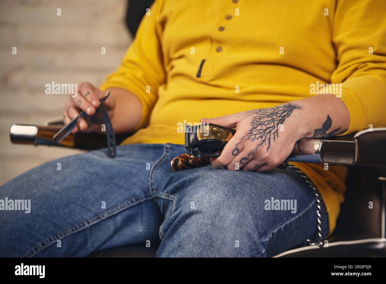 Stylish barber man with hairdressing tools in his hands prepare for ...