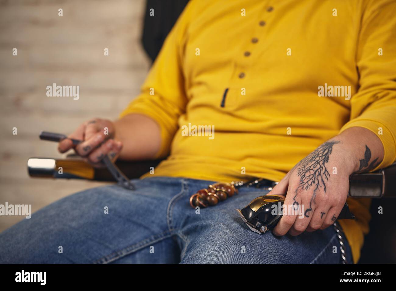 Stylish barber man with hairdressing tools in his hands prepare for ...