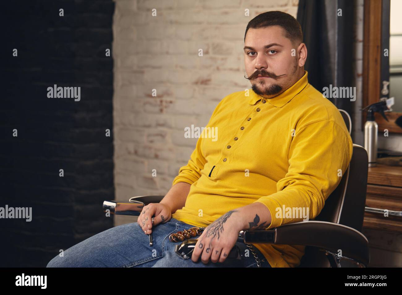 Stylish barber man with hairdressing tools in his hands prepare for ...