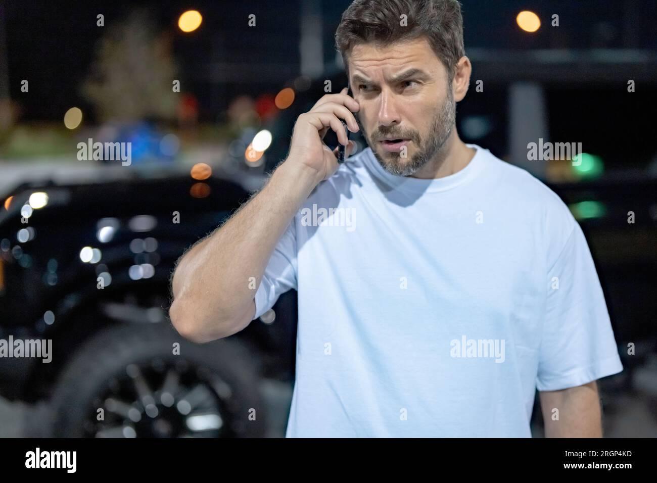 Gangster call phone. Angry man chatting on phone near car on night ...