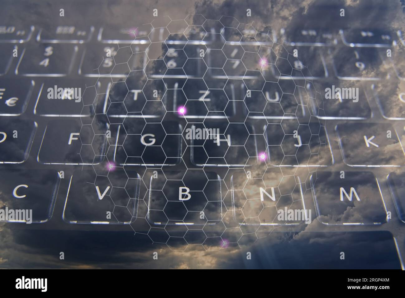 Illuminated computer keyboard with clouds overlay. Transparent network ...