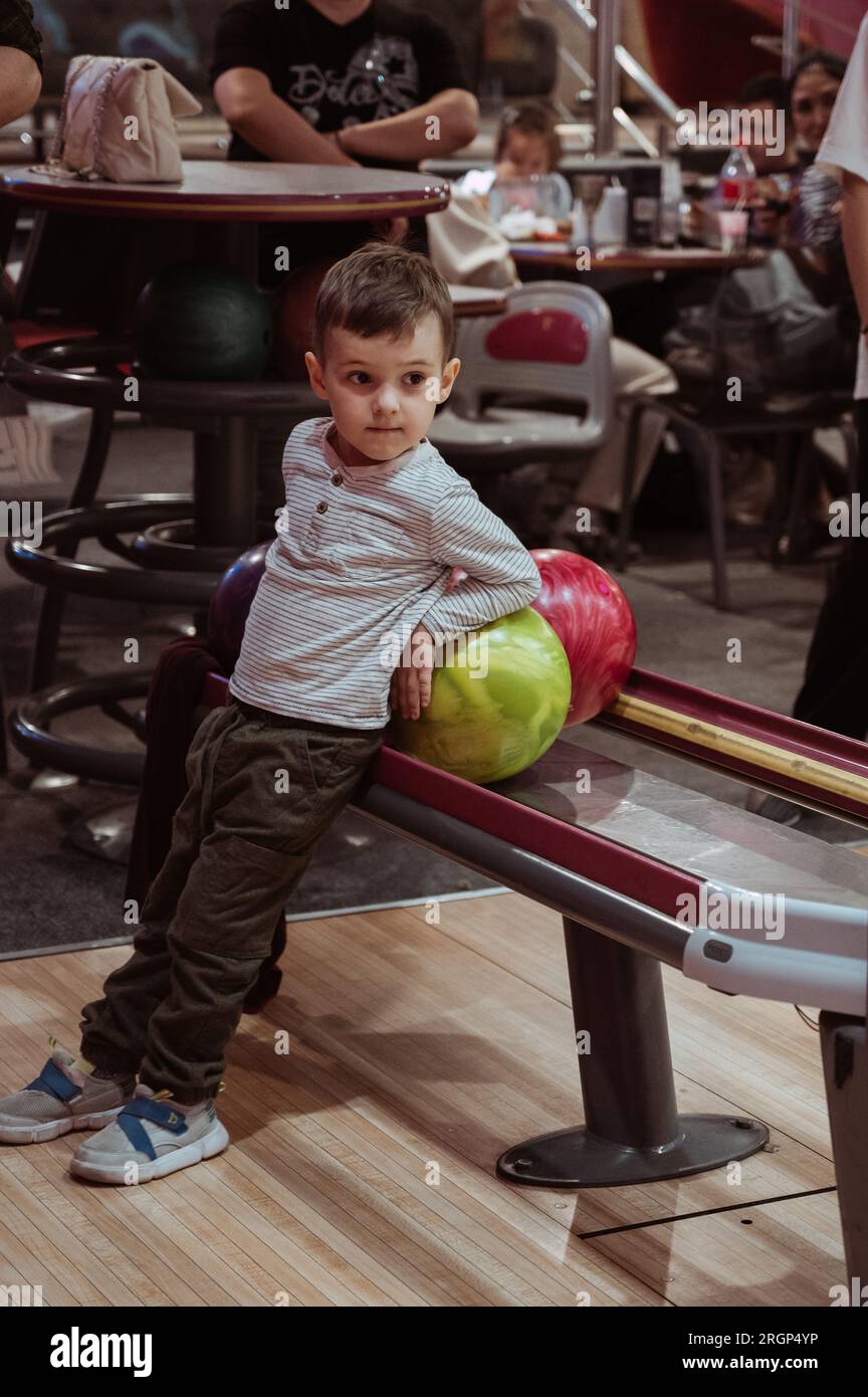 little child boy playing bowling in a club Stock Photo - Alamy