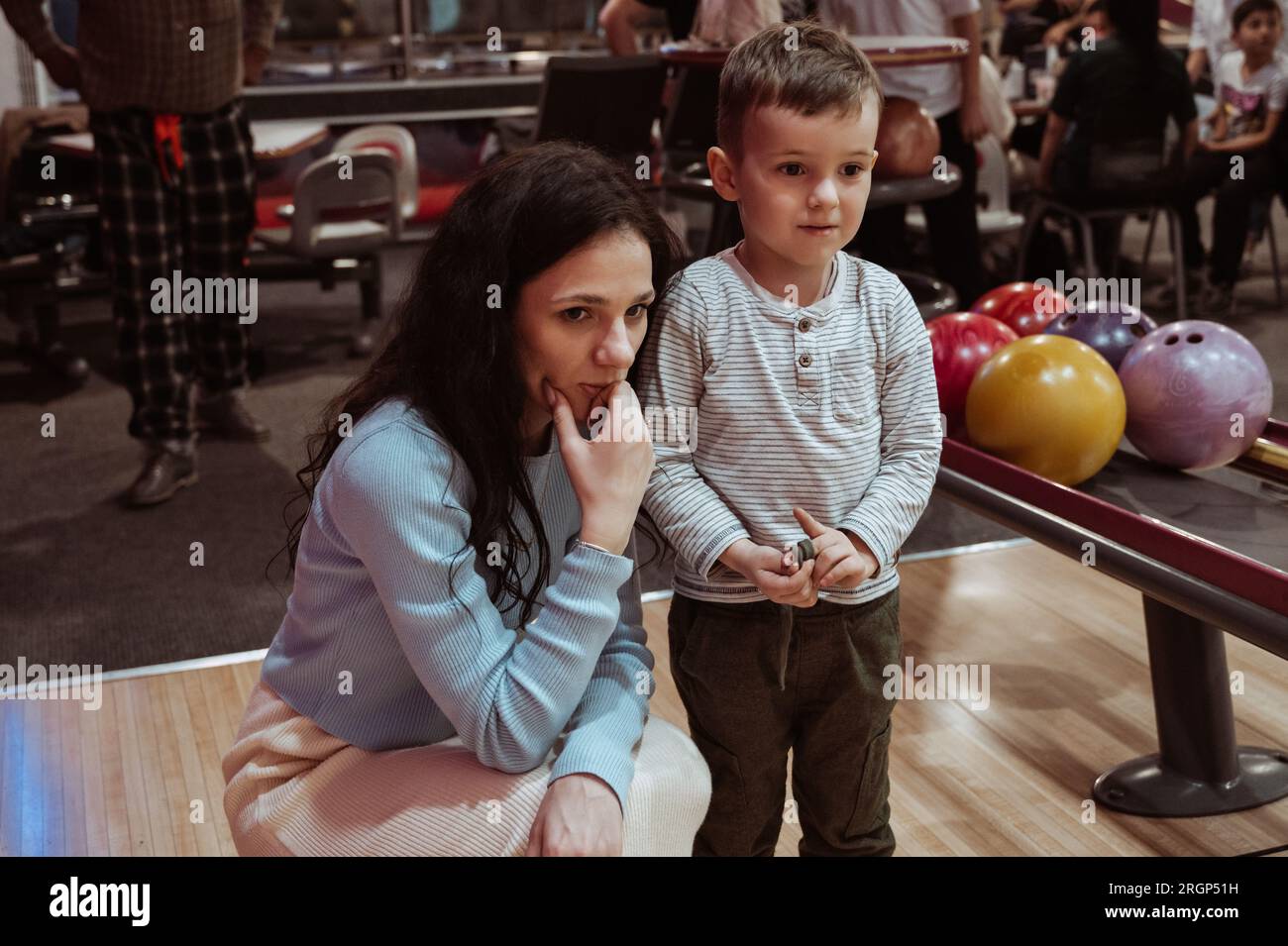 mom and son play bowling in a club Stock Photo - Alamy