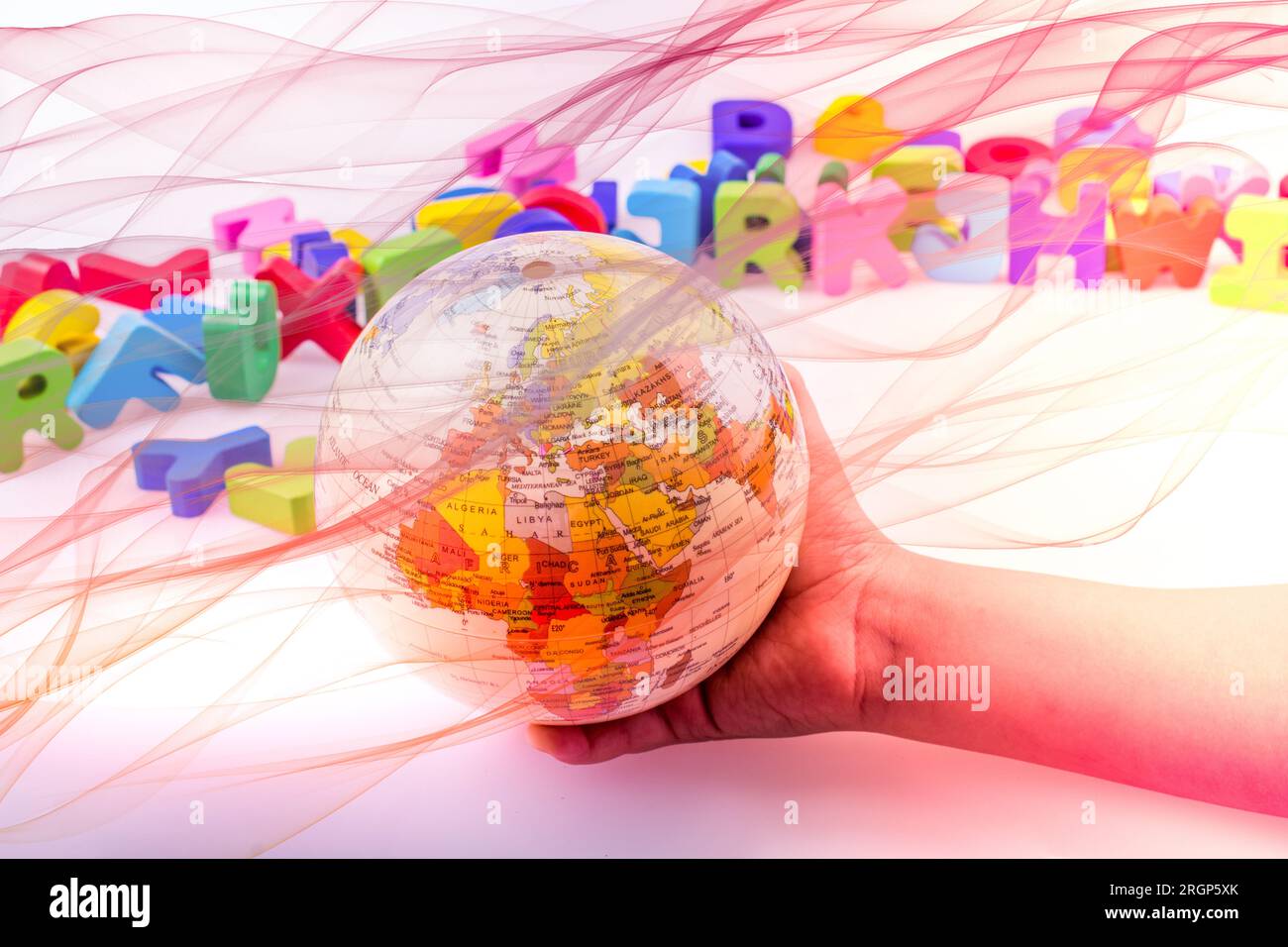Earth globe model in hand by colorful abc letters Stock Photo - Alamy