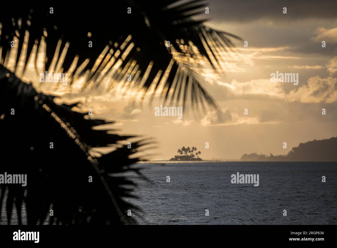 Small French Polynesia island and a stunning sunrise Stock Photo - Alamy