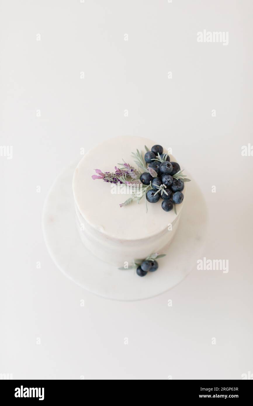 natural white cake with blueberry lavender garnish Stock Photo - Alamy