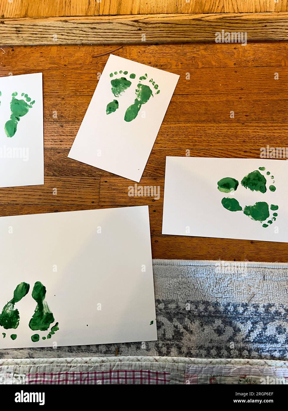 DIY baby art with painted and stamped baby feet on paper Stock Photo ...