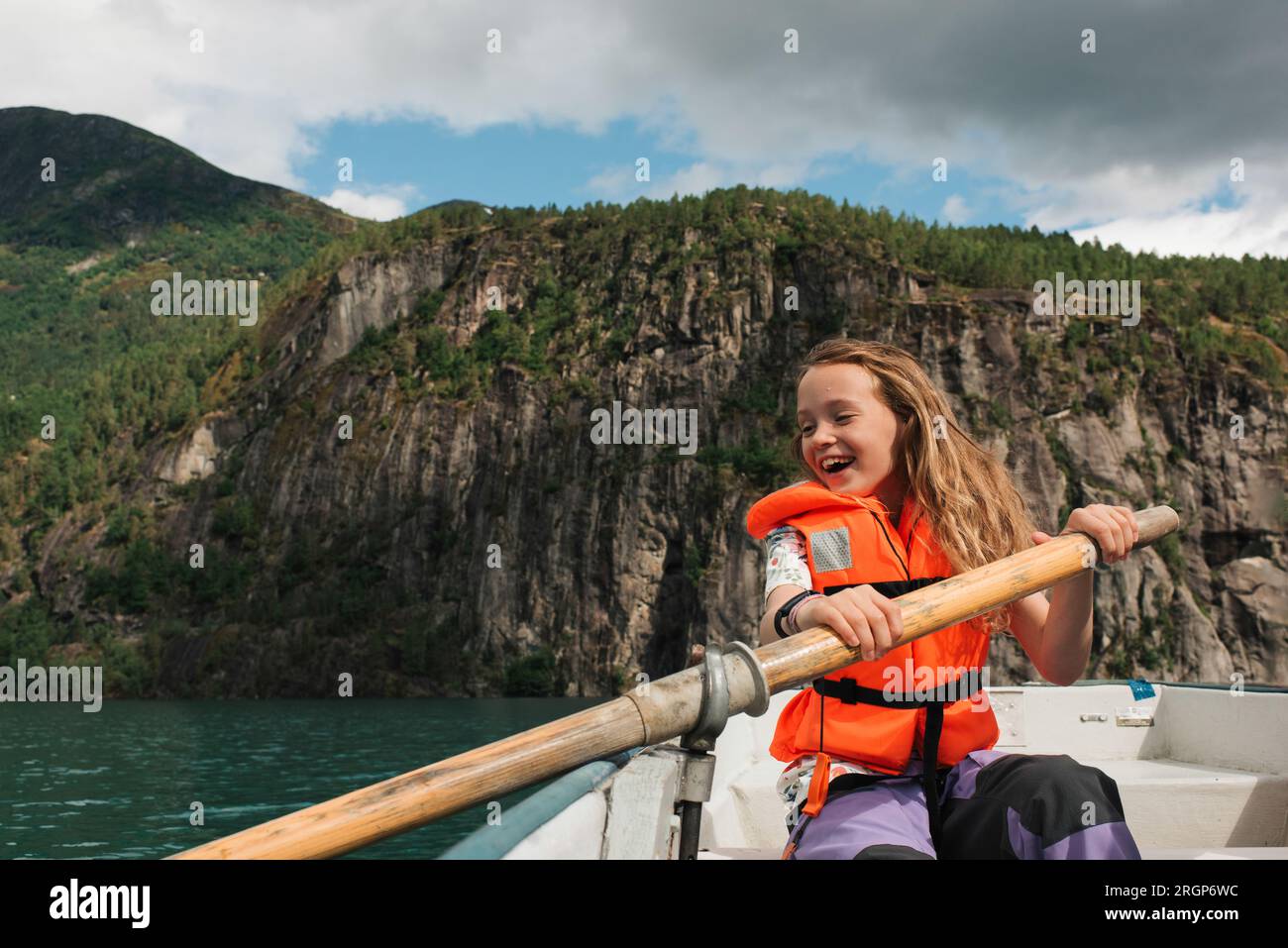 girl happily rowing a boat in the fjords in Norway Stock Photo - Alamy