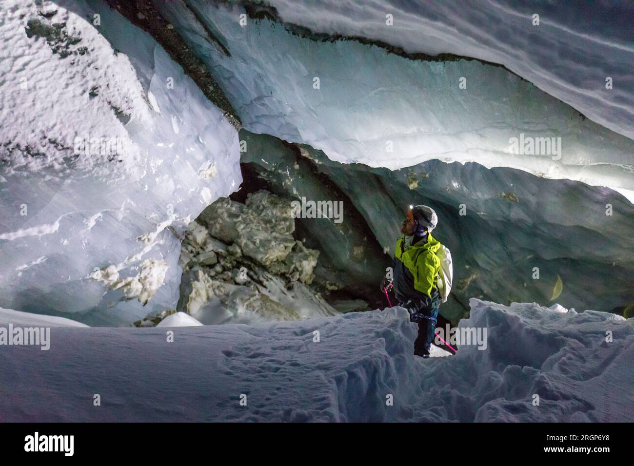Explorer and climber rappels in ice and snow cave Stock Photo - Alamy