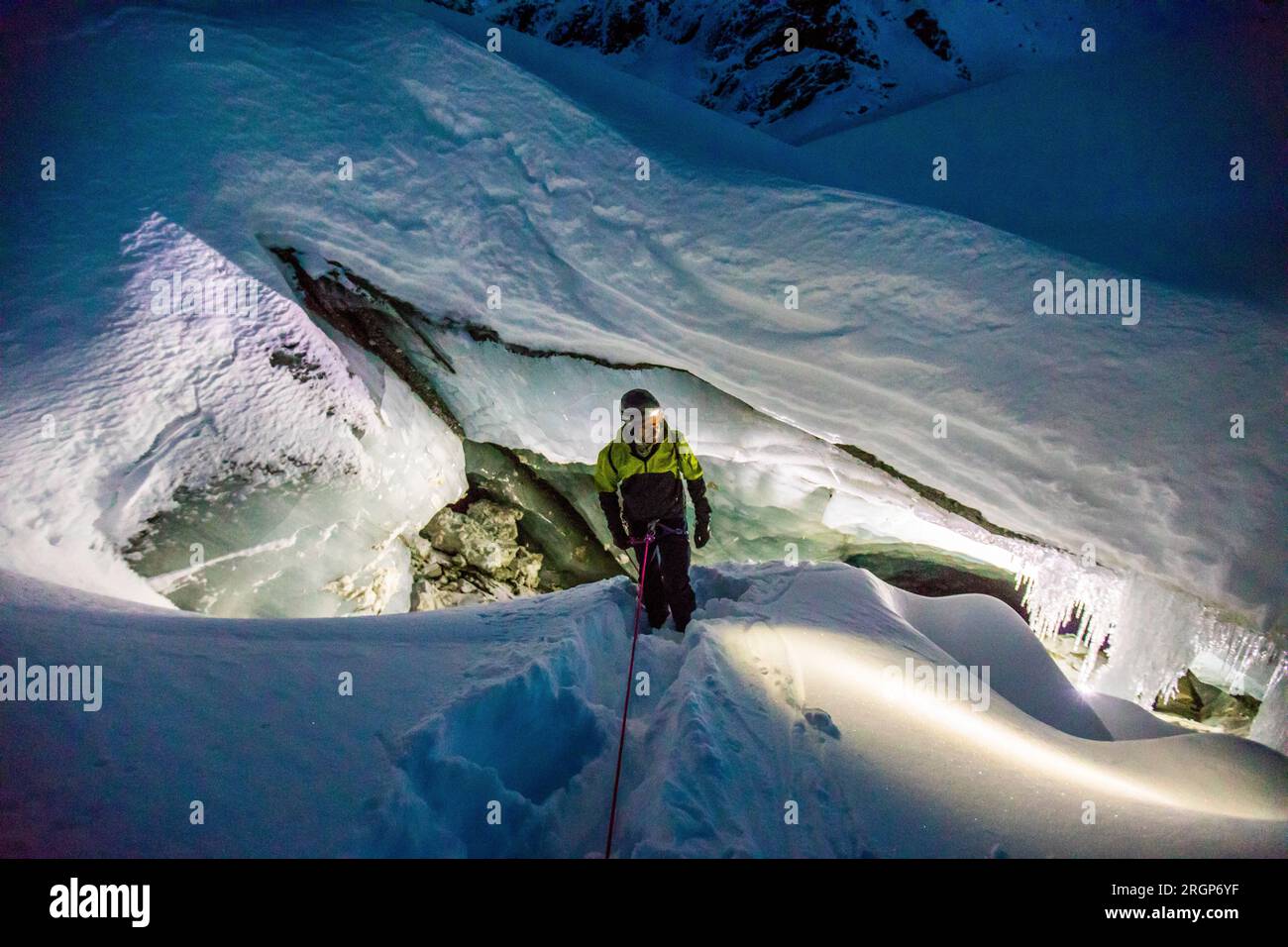 climber on rope rappelling into glacial ice cave Stock Photo - Alamy