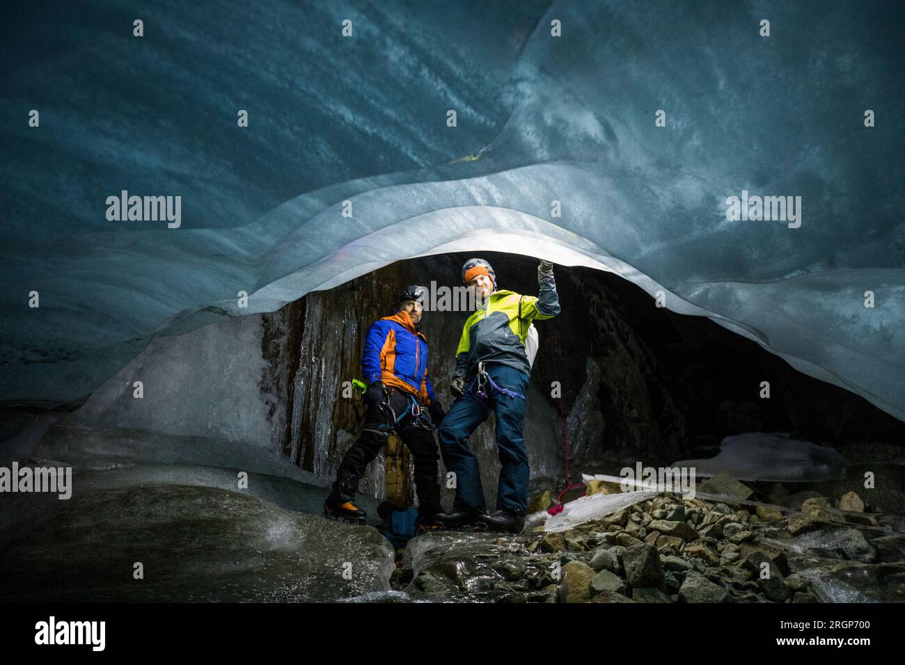 Portrait of two explorers wearing climbing gear in ice cave Stock Photo ...