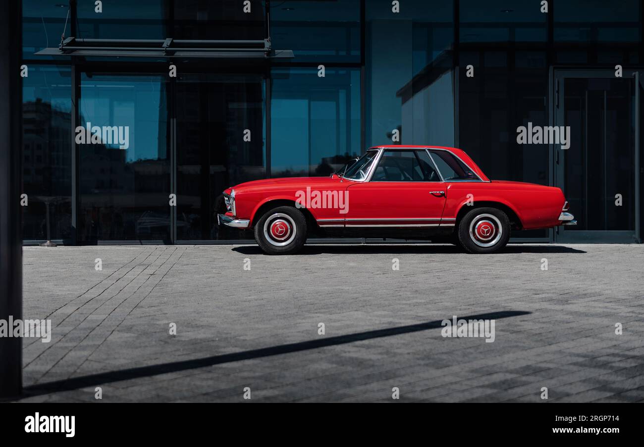 Side profile view of red classic Mercedes-Benz SL W113 Pagoda roadster ...