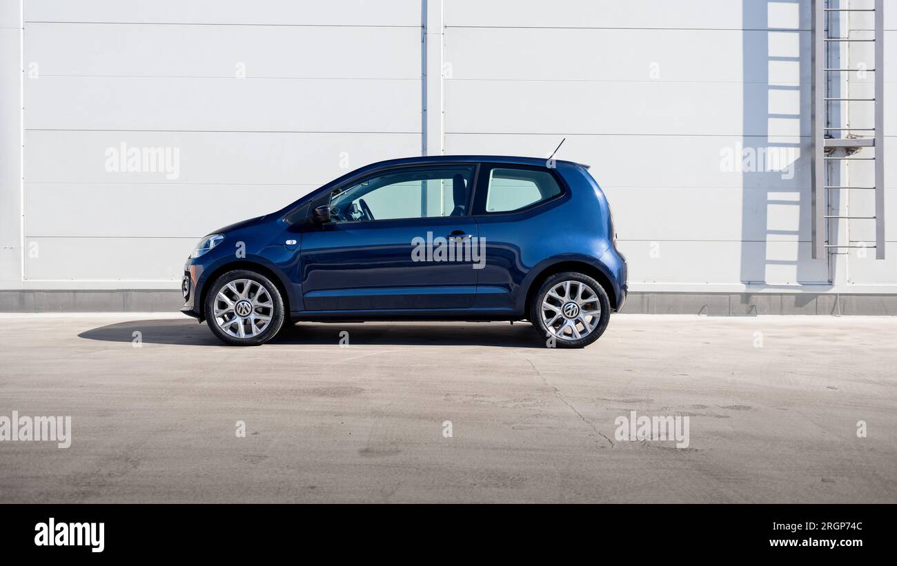 blue compact hatchback Volkswagen Up! side profile view parked near the ...