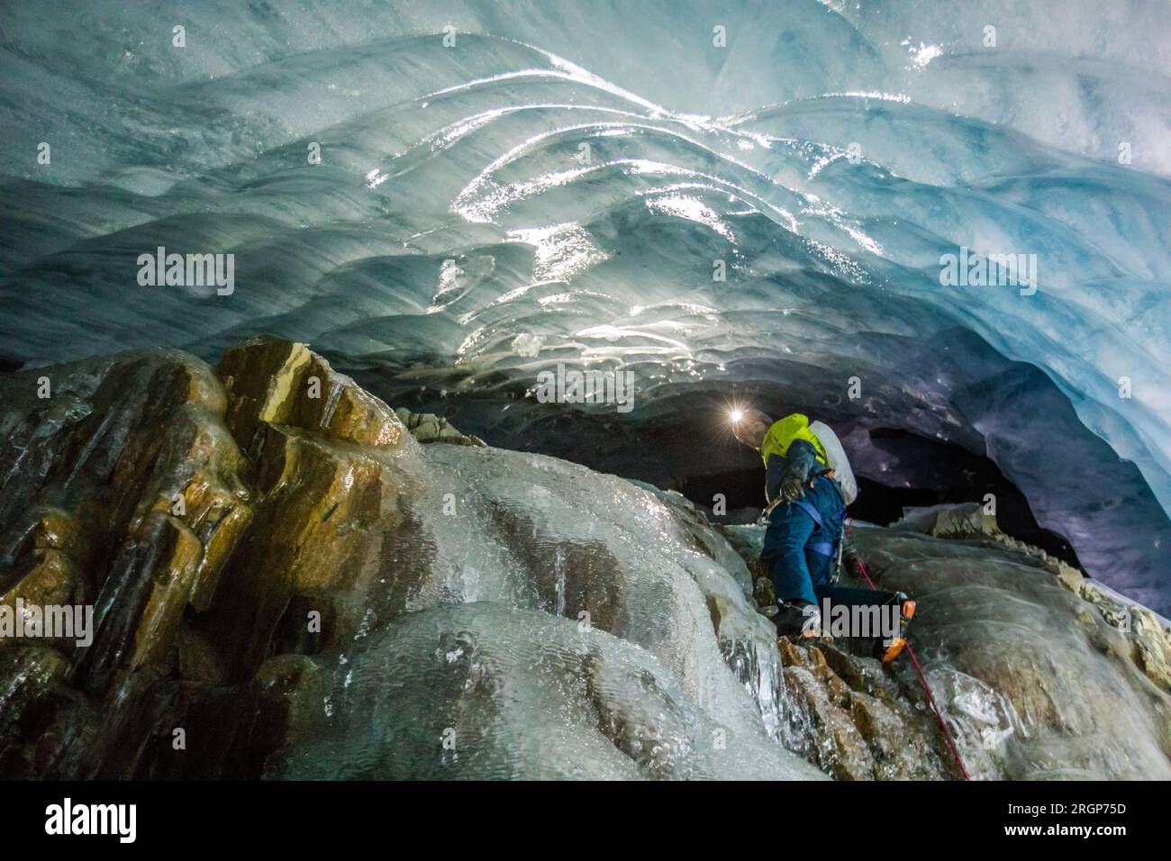 low angle view of ice climber looking down from inside cave Stock Photo ...