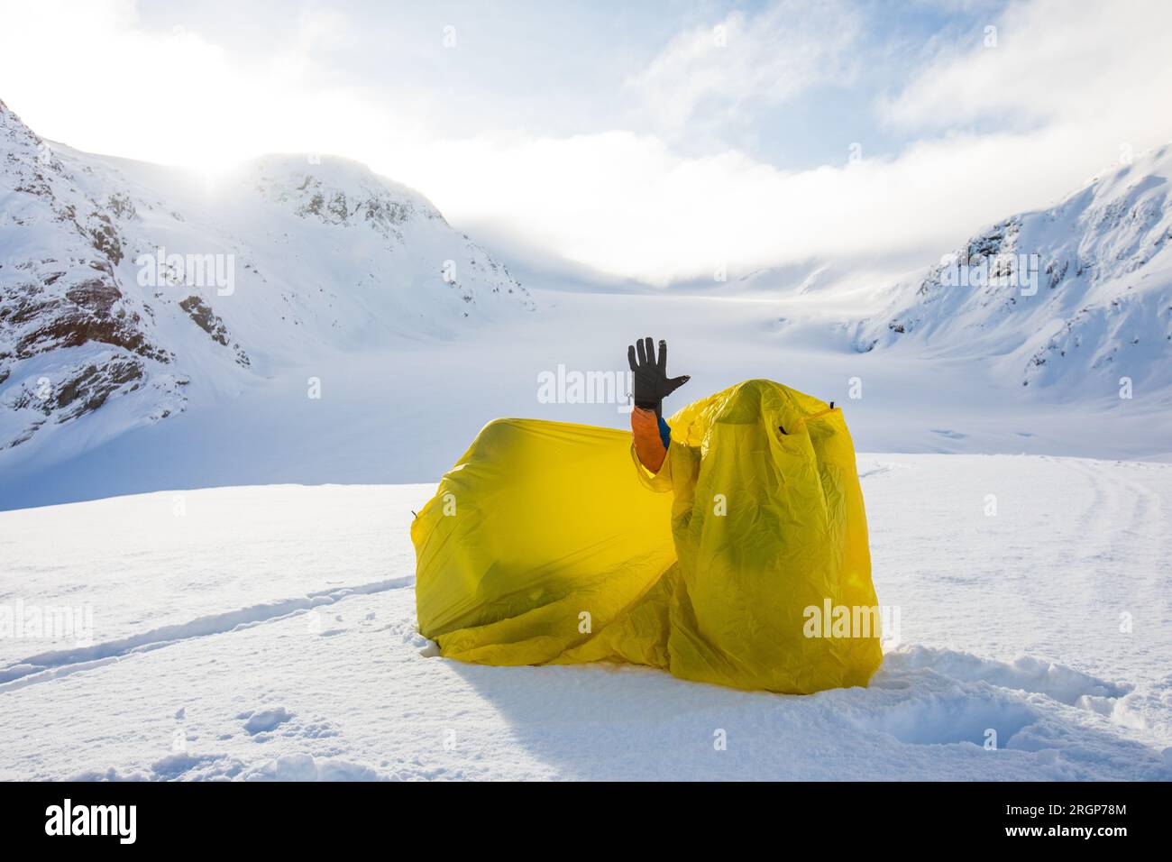 Hand sticking out, waving from inside yellow tent shelter Stock Photo ...