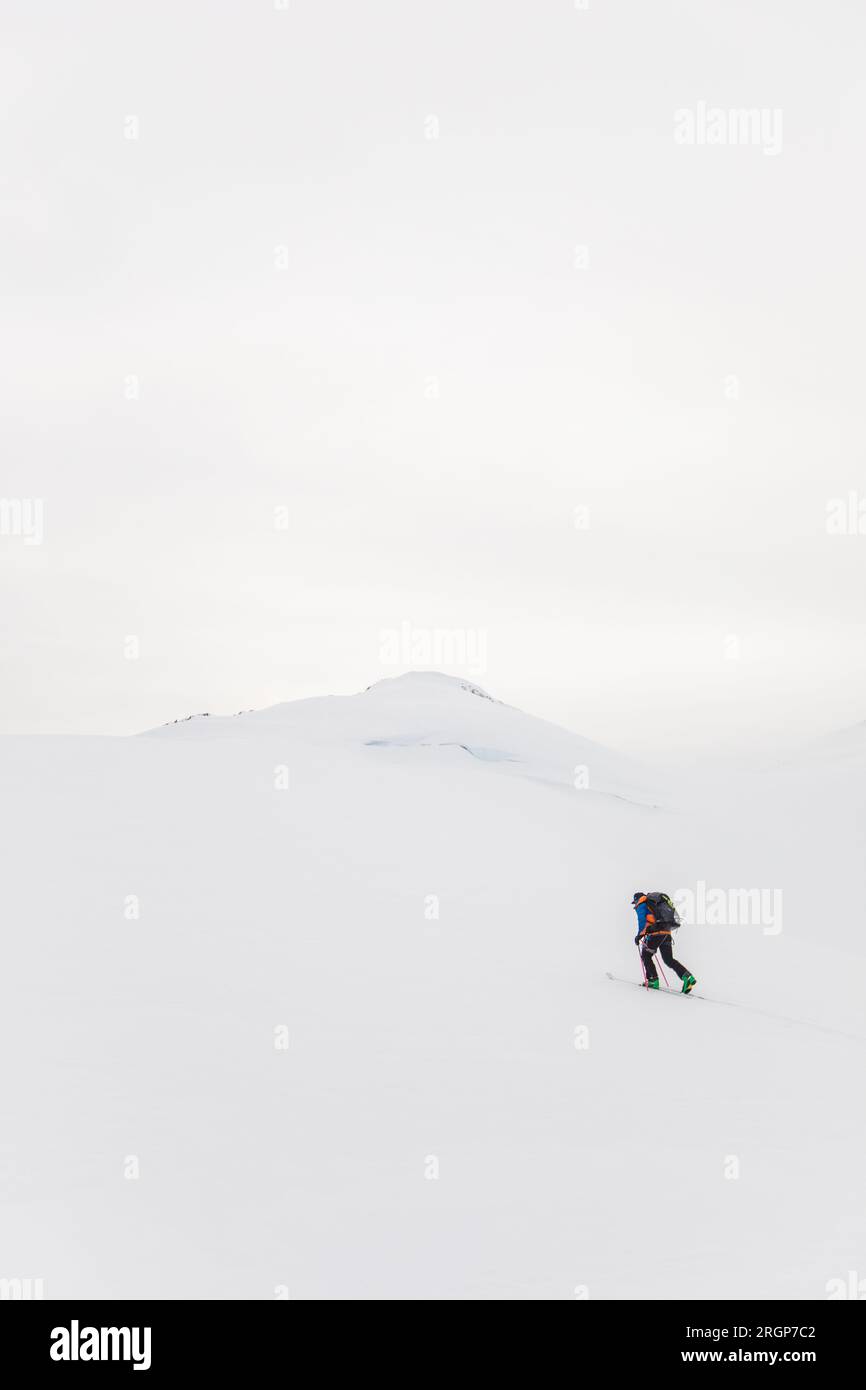 Rear view of skier skinning, heading to mountain summit Stock Photo - Alamy