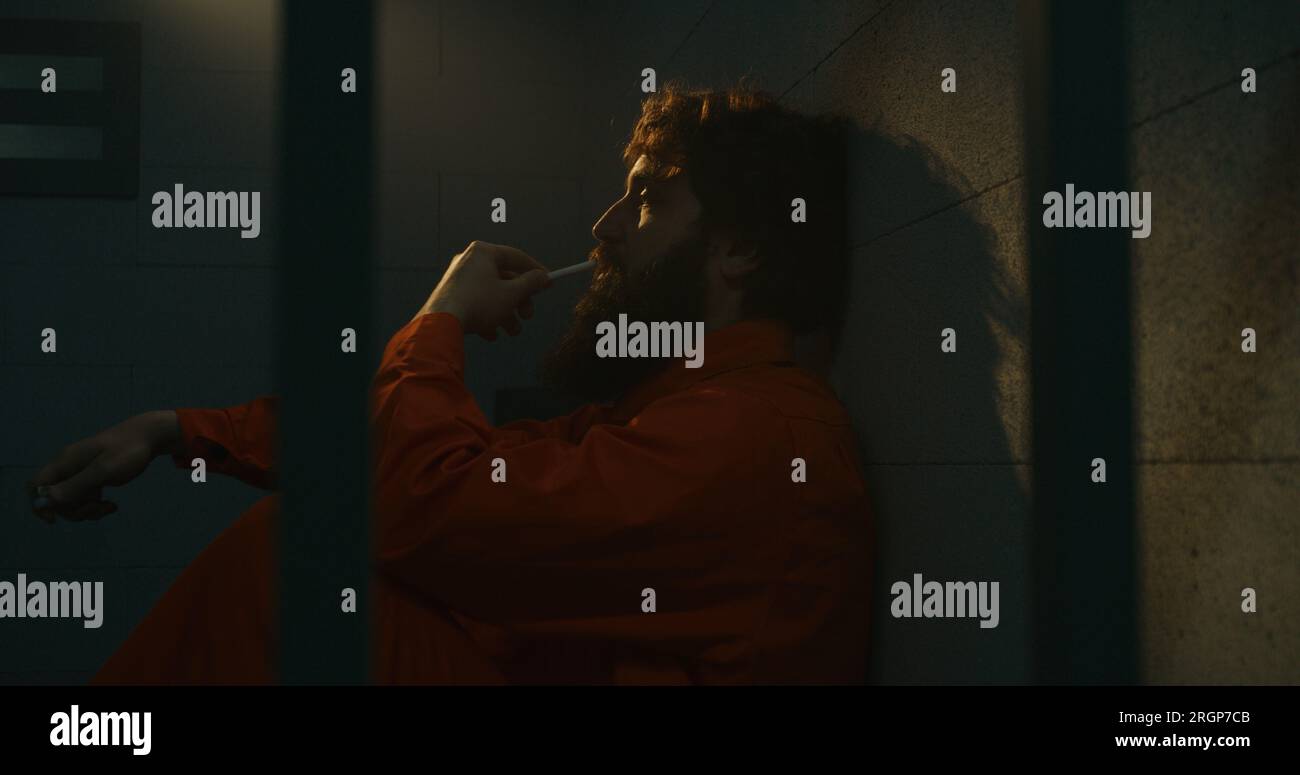 Man sits in jail cell hi-res stock photography and images - Alamy