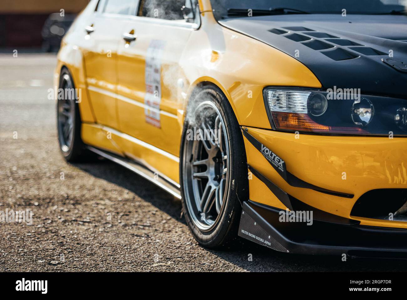 yellow Milsubishi Lancer Evo IX after few hot laps at local track event ...