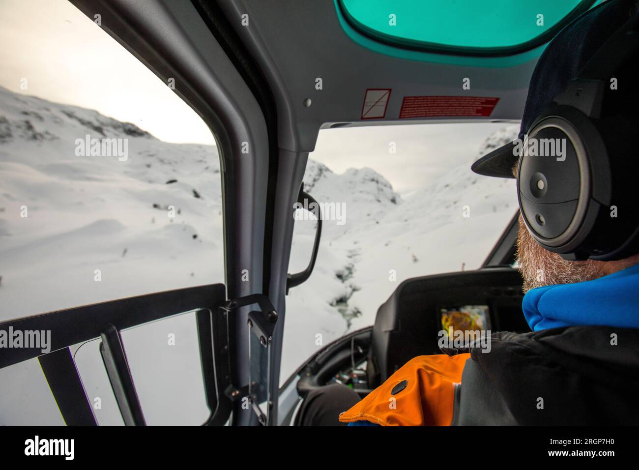 rear view of passenger looking out window of helicopter Stock Photo - Alamy