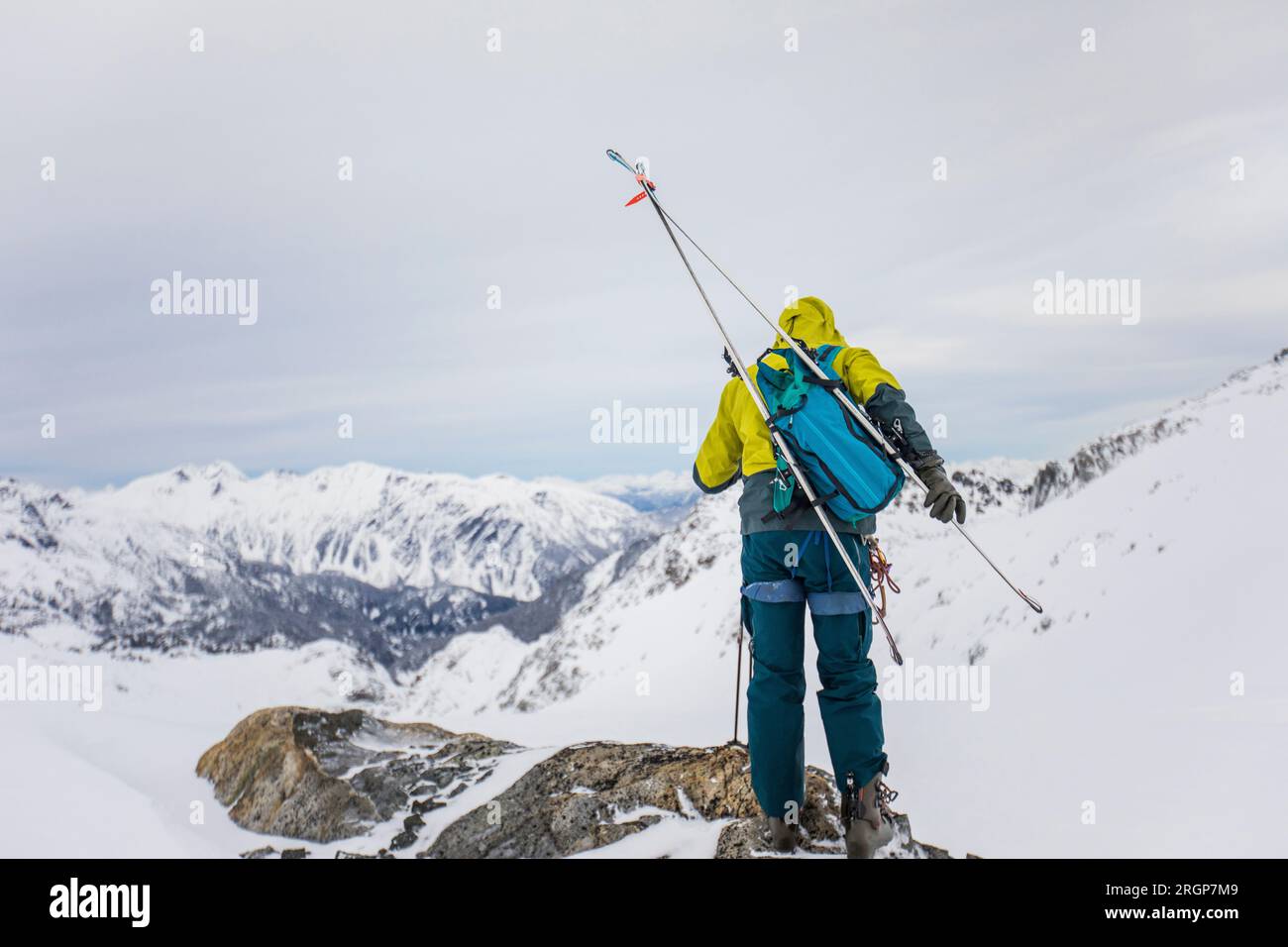 Rear view of Skier slinging backpack over one shoulder Stock Photo - Alamy