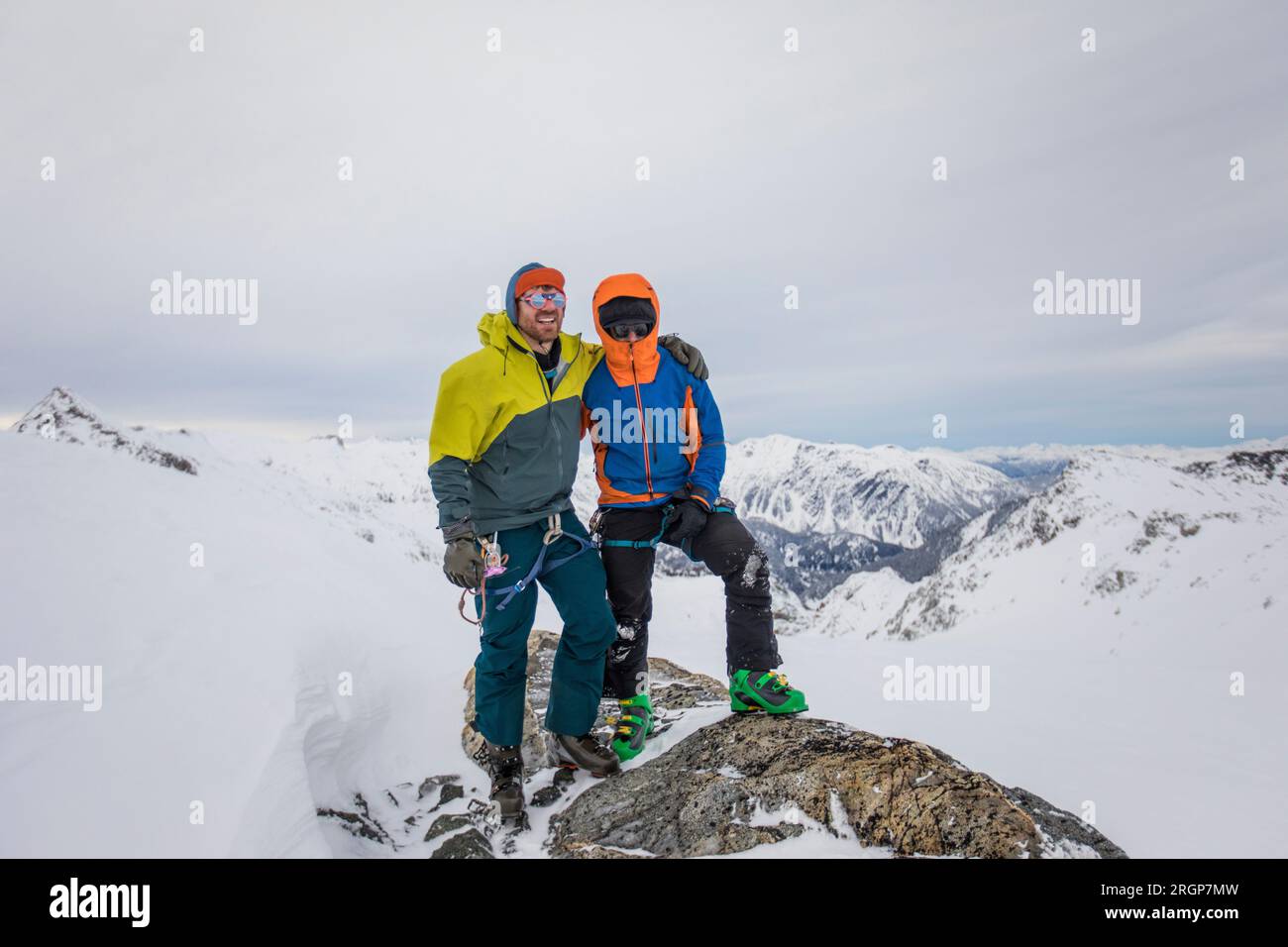 Friends embrace, pose for picture on mountain summit Stock Photo - Alamy