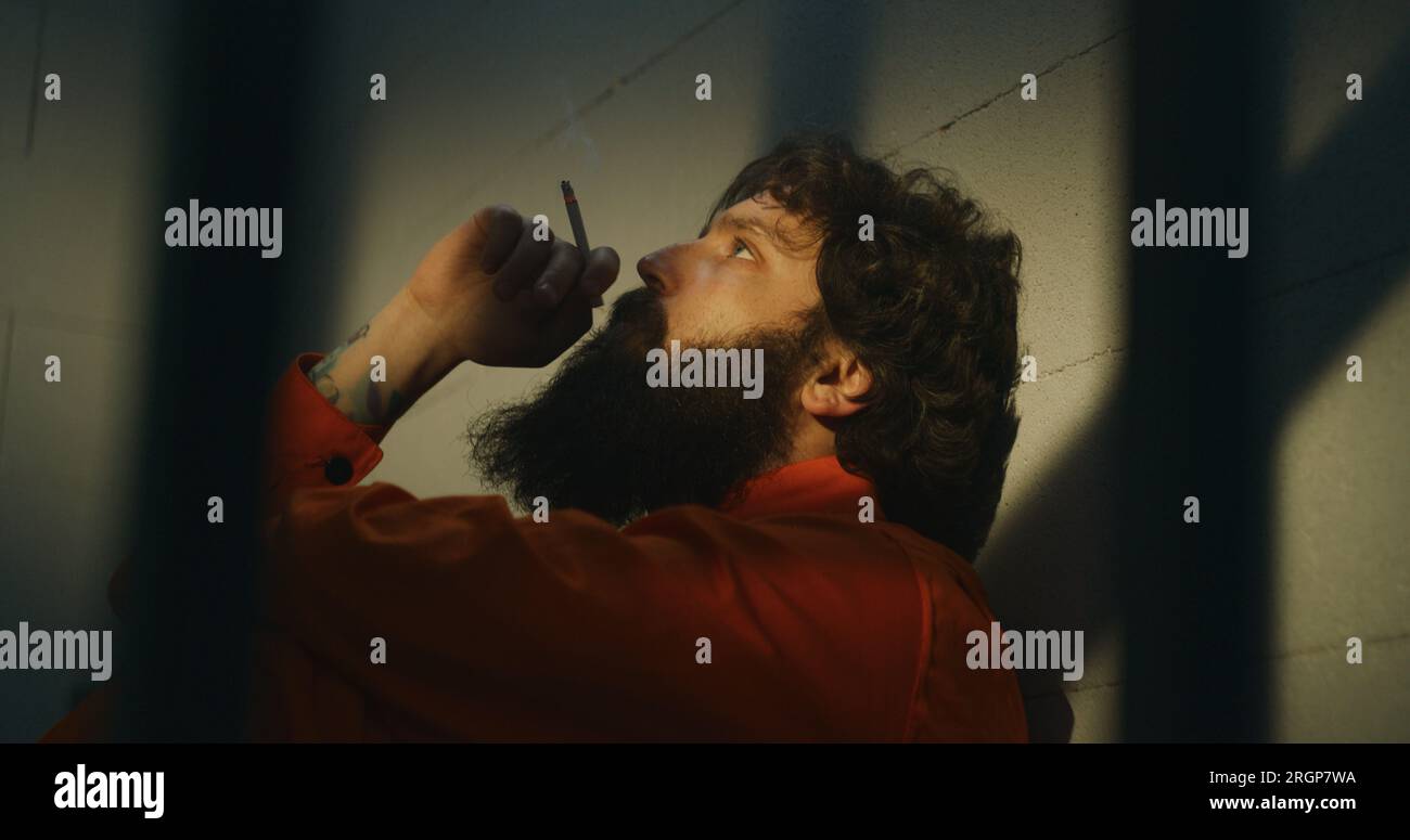 Man sits in jail cell hi-res stock photography and images - Alamy