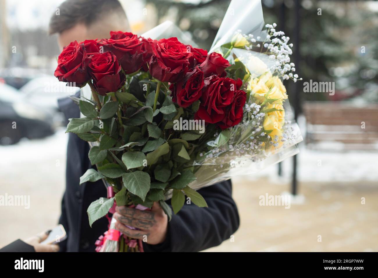 Bouquet of flowers. Man holds flowers in his hand. Details of holiday ...