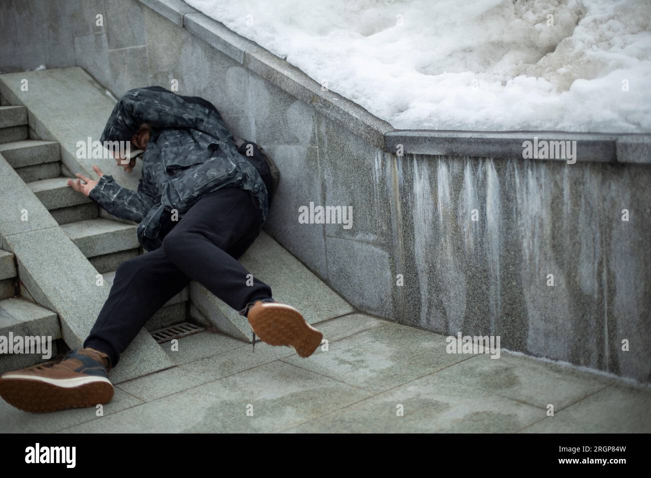 Man fell. Guy is lying on pavement. Falling on stairs. Man stumbled ...