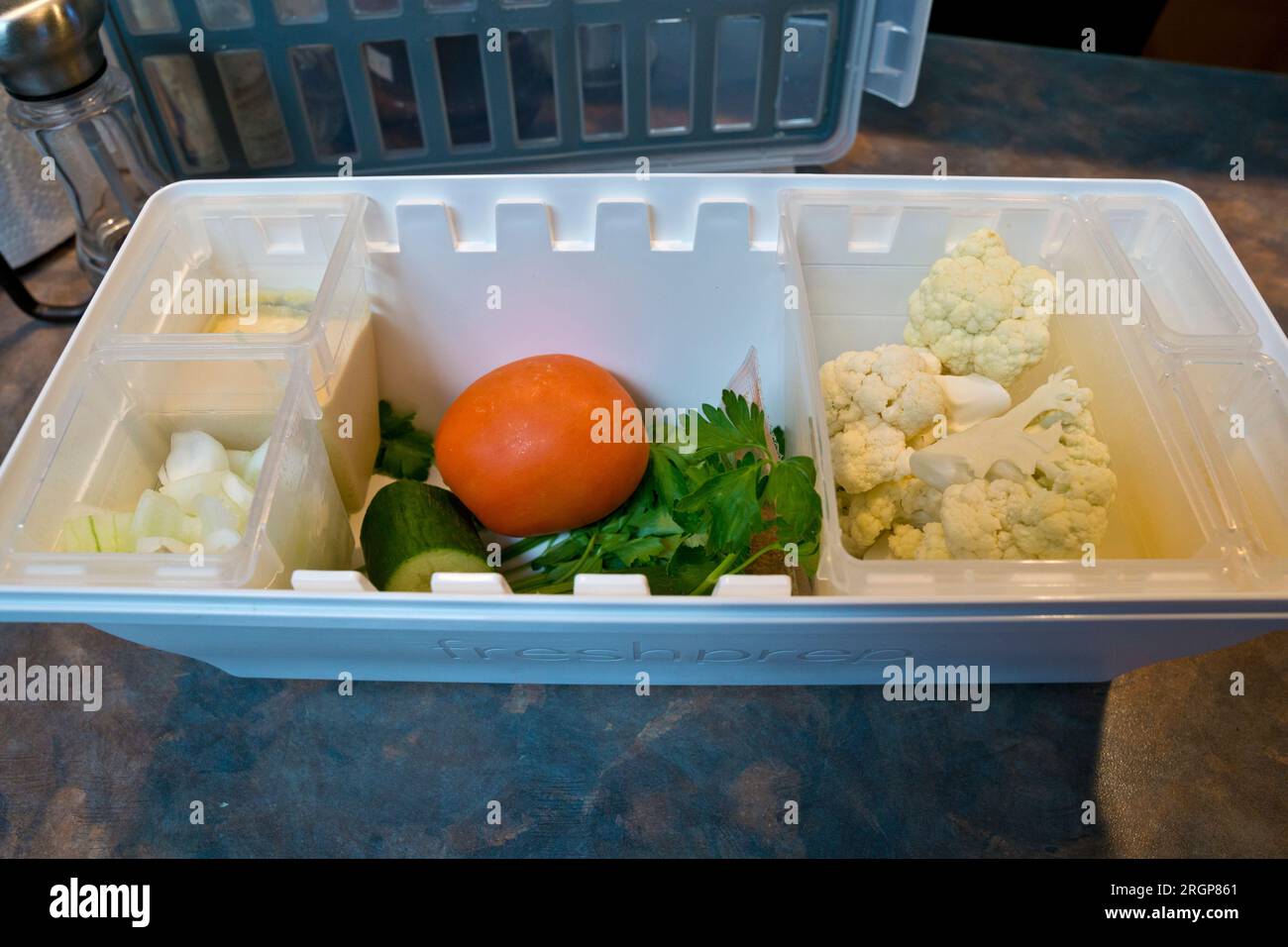 Packaged ready to cook meal kit in a reusable container. Fresh Prep ...