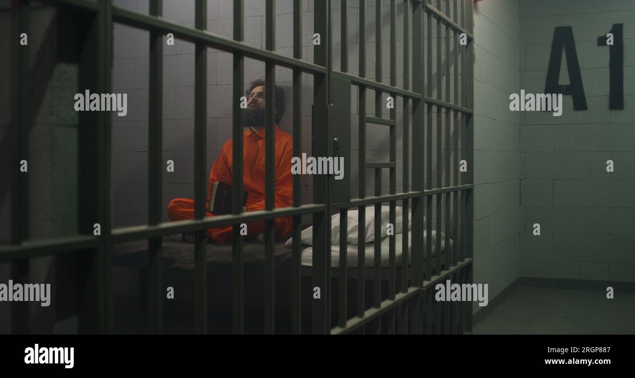 Man sits in jail cell hi-res stock photography and images - Alamy