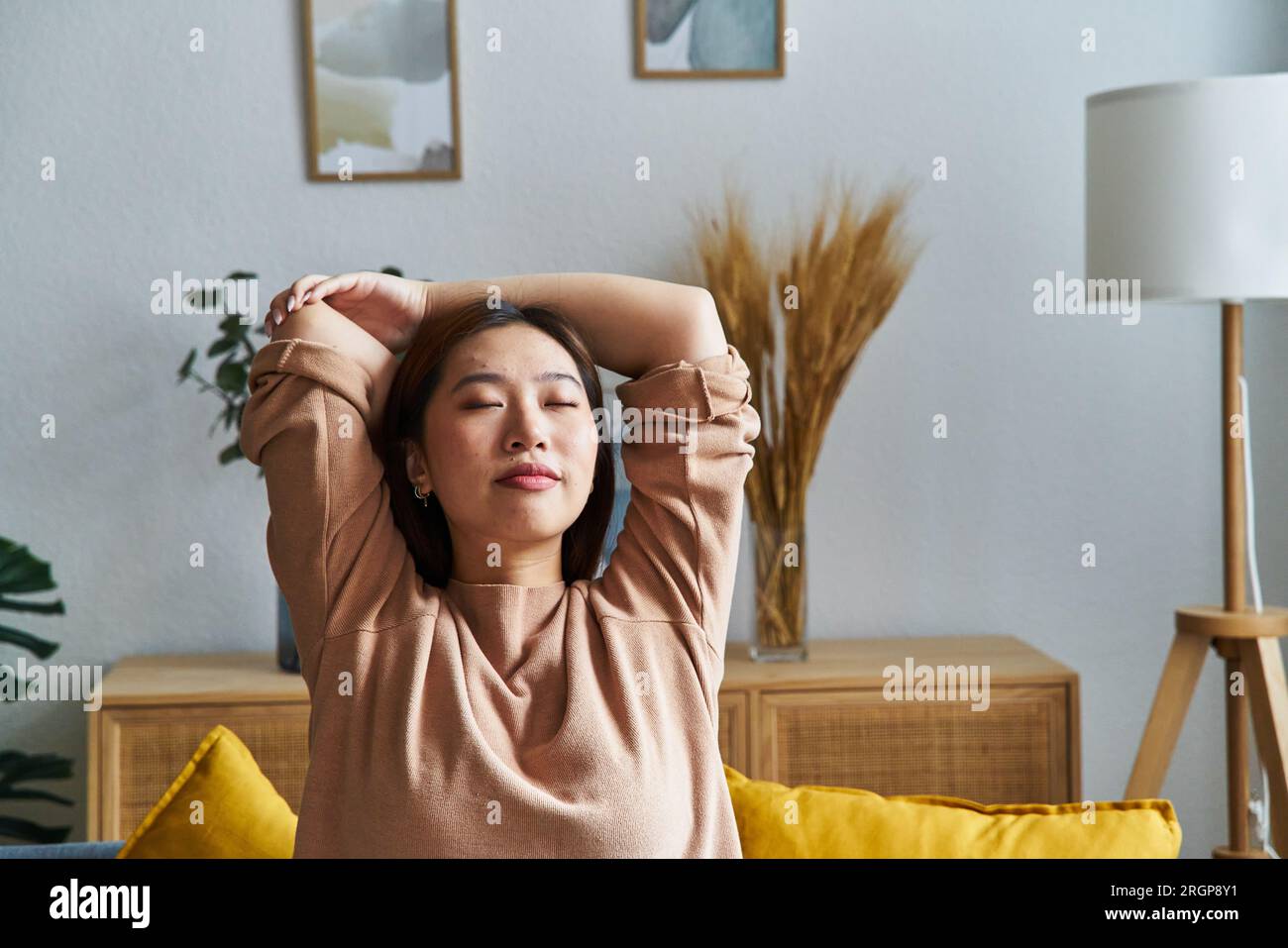 woman stretching arms and relaxing at home Stock Photo - Alamy