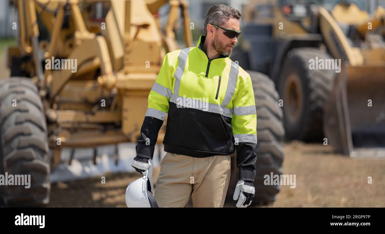 Worker with bulldozer on site construction. Man excavator worker ...
