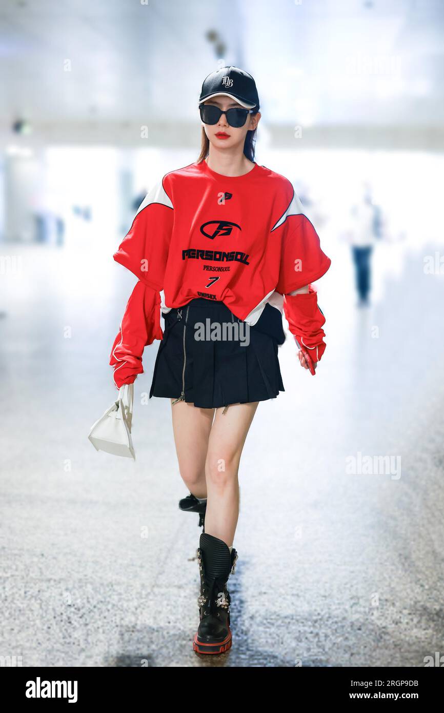 Chinese singer and actress Qi Wei appears at the airport in Shanghai ...