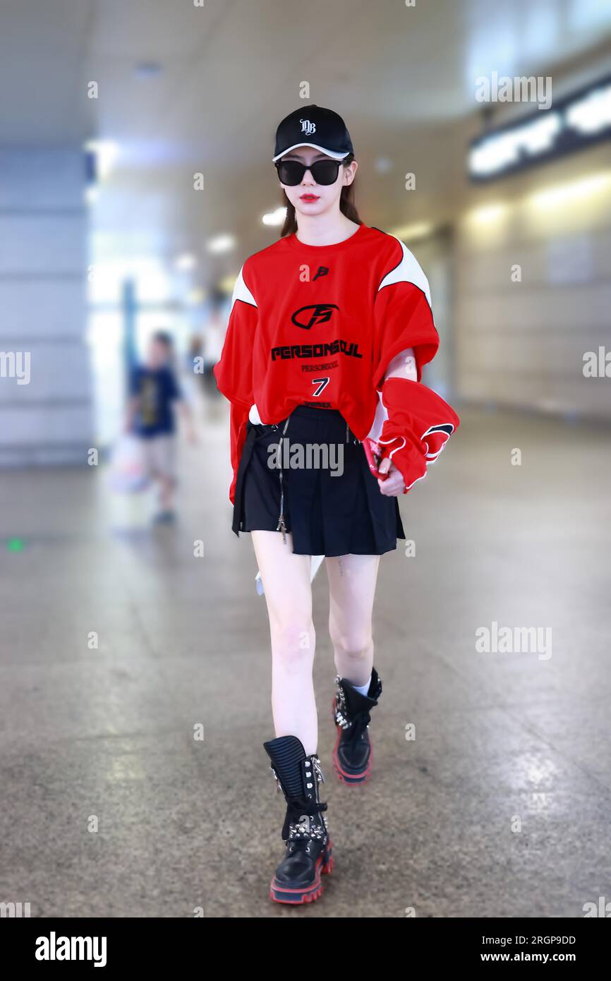 Chinese singer and actress Qi Wei appears at the airport in Shanghai ...