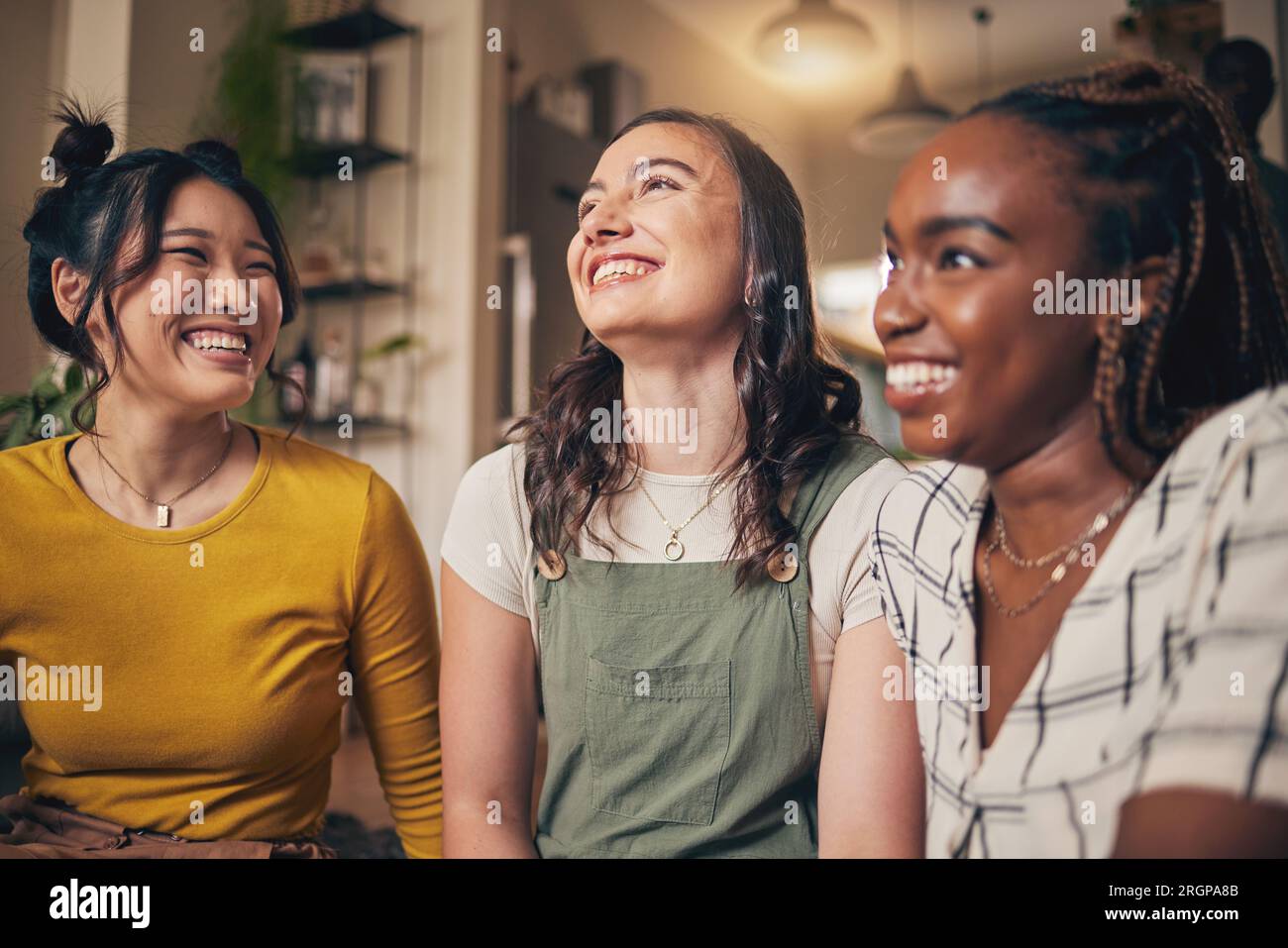 Happy, friends and women in a living room with funny, conversation and ...