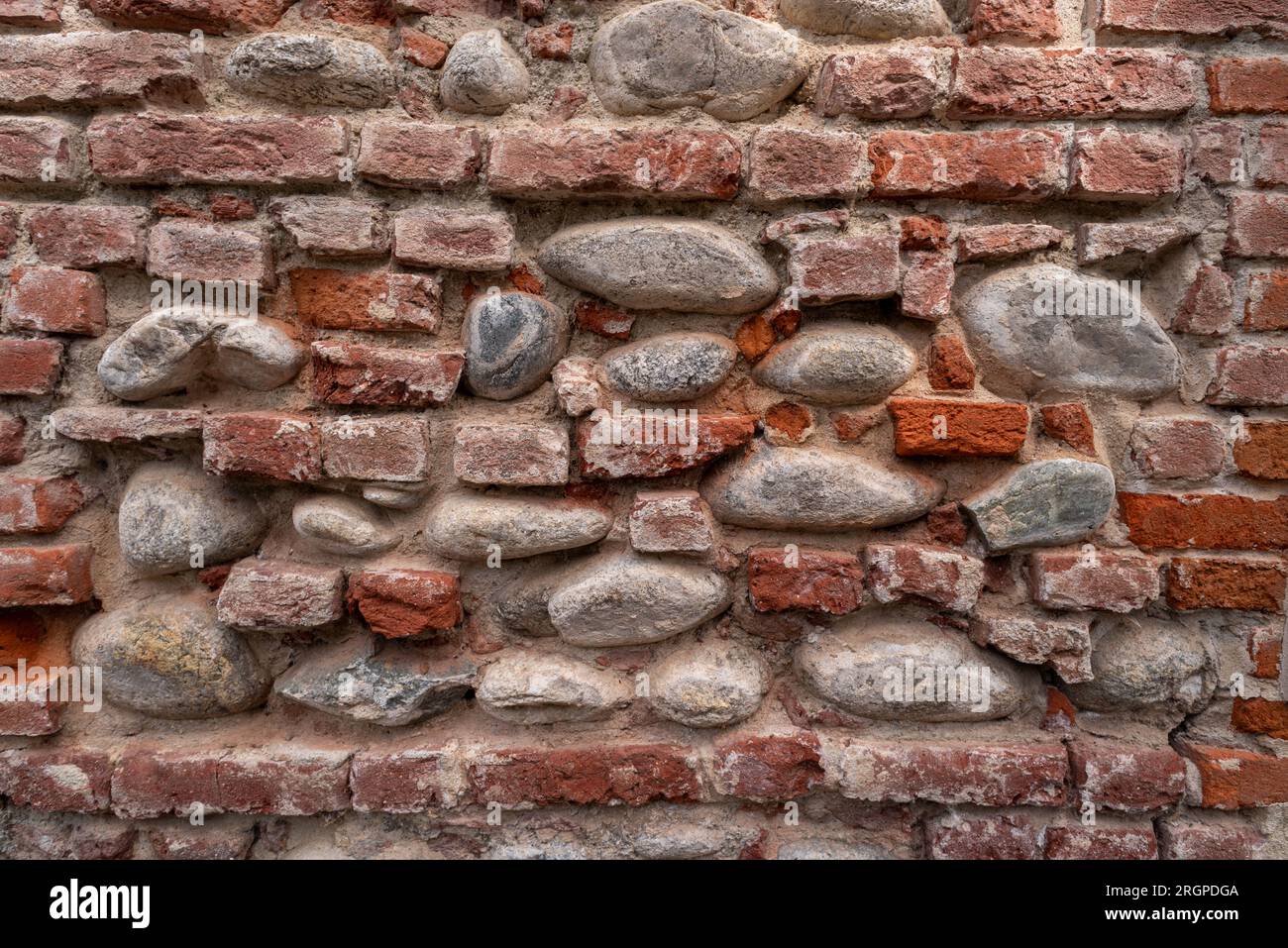 Texture of wall with regular red brick and with pieces of old red brick ...