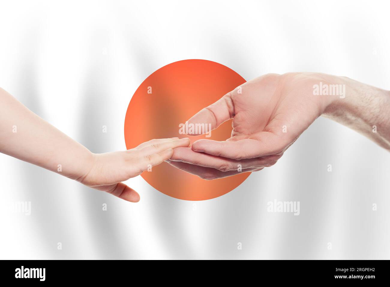 Japanese baby and parent hands on the background of flag of Japan Help, aid, support, charity ...