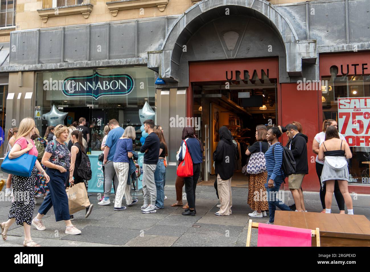 People queueing at Cinnabon - an American bakery chain, recently opened in the city of Newcastle ...