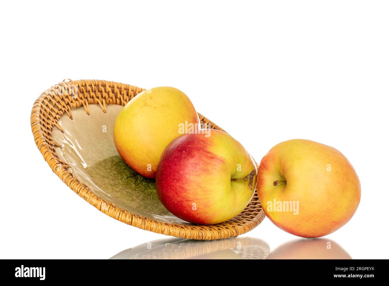 Three sweet juicy apples in a ceramic plate, macro, isolated on white ...
