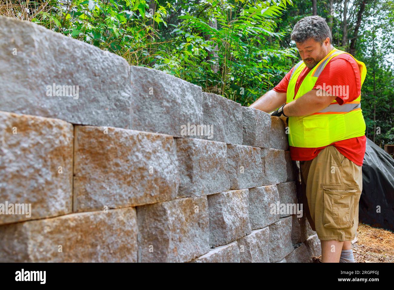 Construction worker skillfully fastened concrete block in place on ...